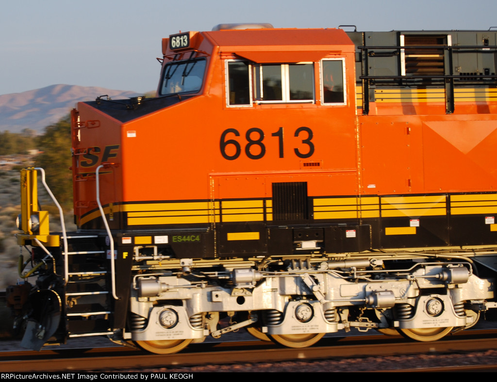 Zoom in shot of the cab of BNSF 6813 as the Rising California Sun Gleems off her paint.